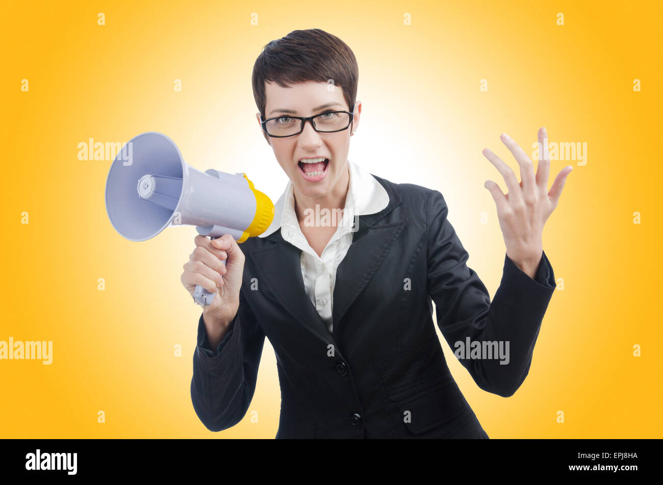 Young business lady screaming to loudspeaker Stock Photo - Alamy