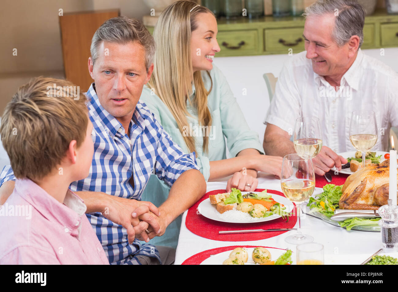 Family speaking together at christmas dinner Stock Photo - Alamy