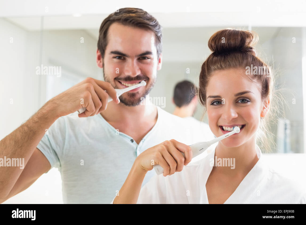 Young couple brushing their teeth Stock Photo - Alamy