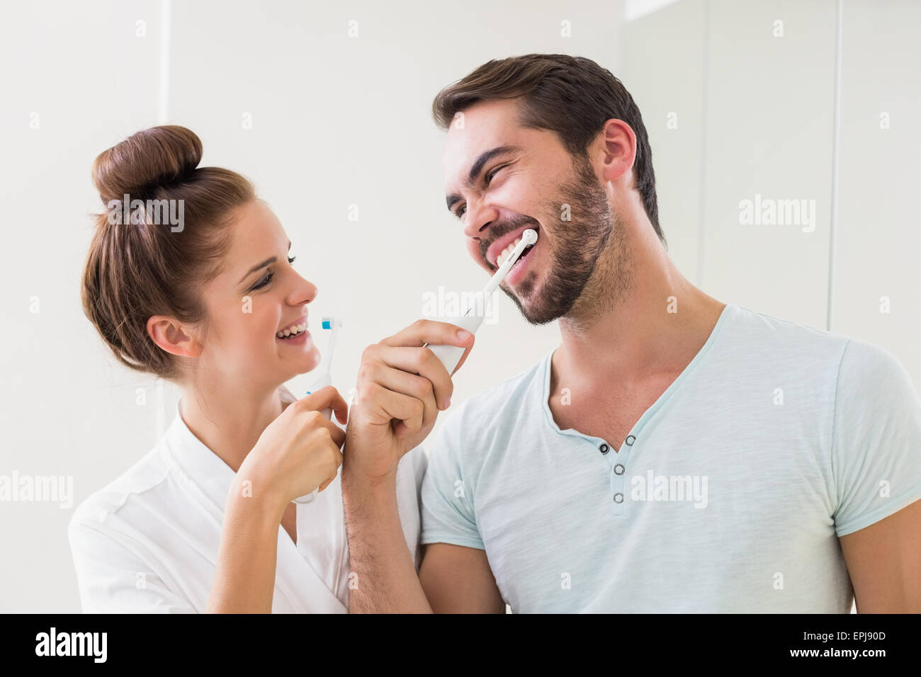 Young couple brushing their teeth Stock Photo - Alamy