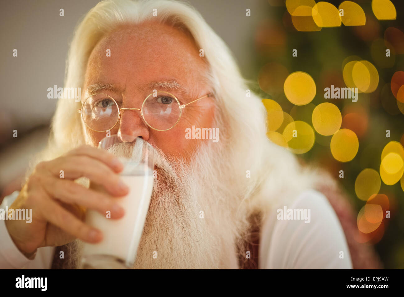 Santa claus drinking a glass of milk Stock Photo - Alamy