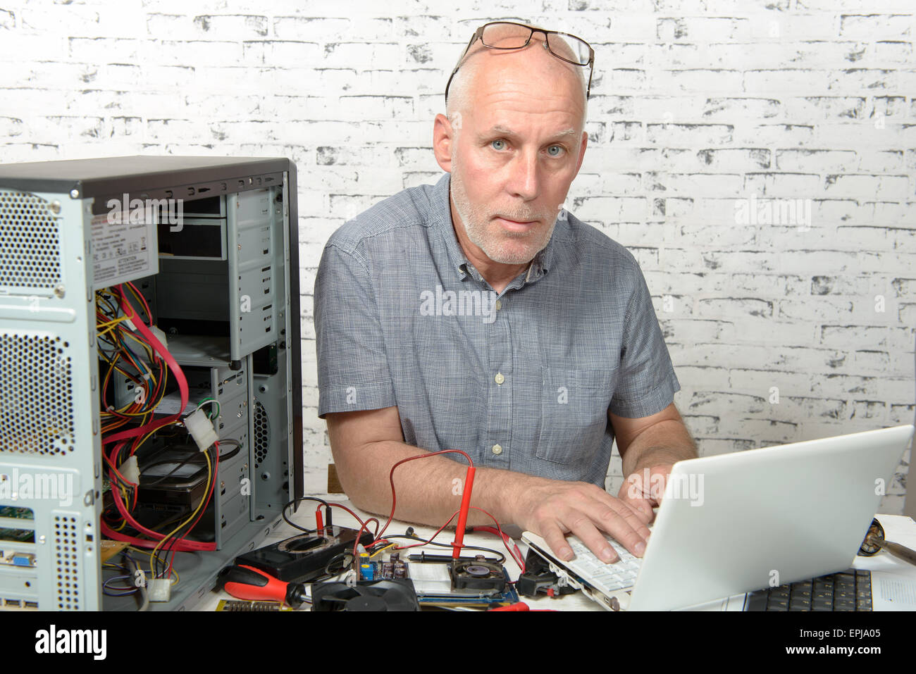 a technician repairing a computer with different tools Stock Photo - Alamy