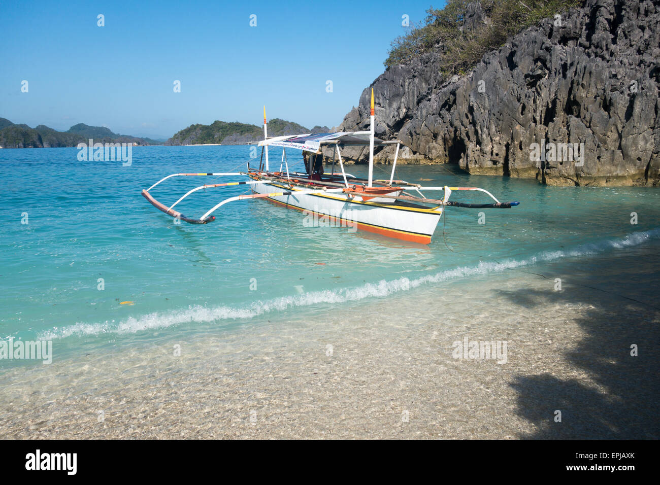 A fishing boat at a tropical beach Stock Photo - Alamy