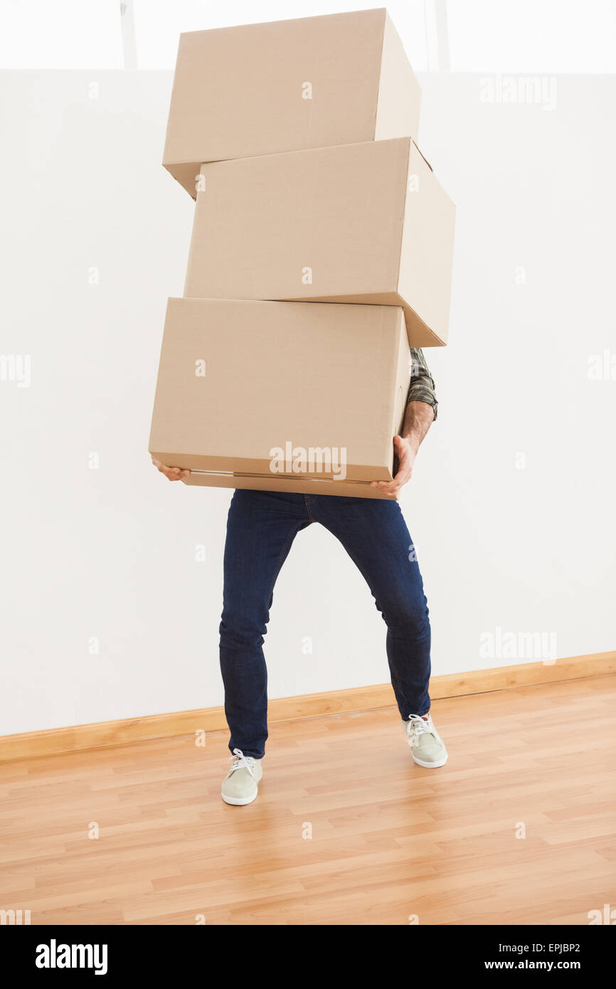 Man balancing heavy cardboard boxes Stock Photo - Alamy