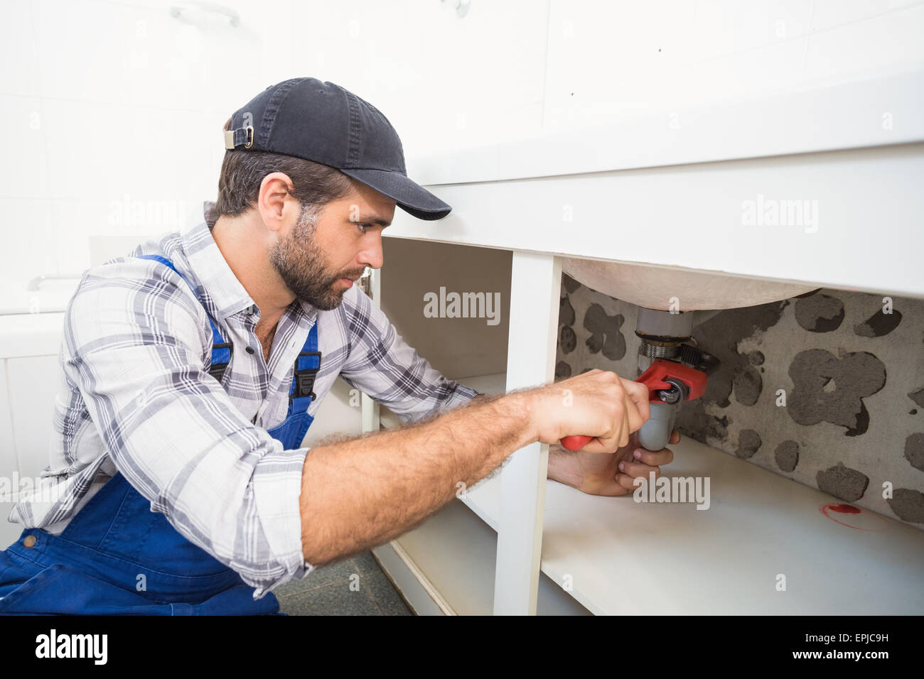 Man repairing plumbing under hi-res stock photography and images - Alamy