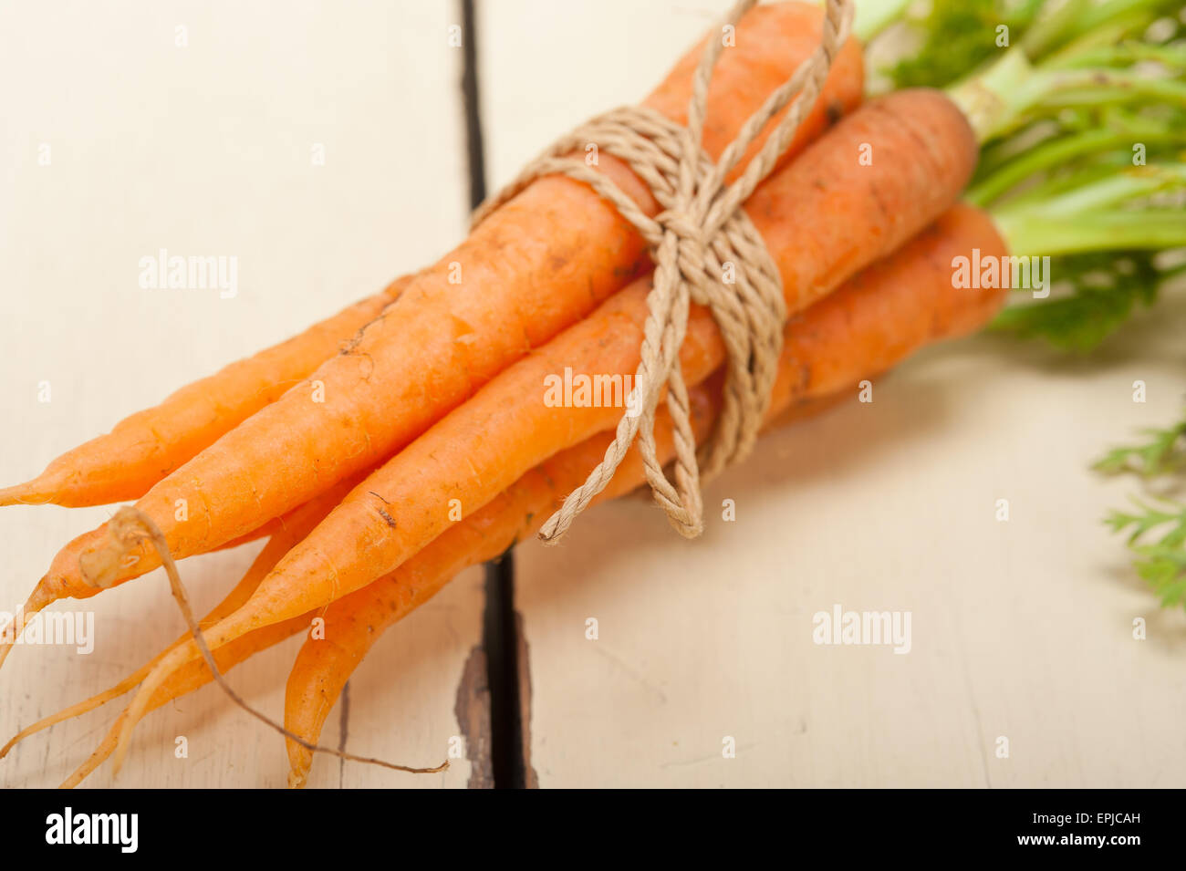 baby carrots bunch tied with rope Stock Photo - Alamy