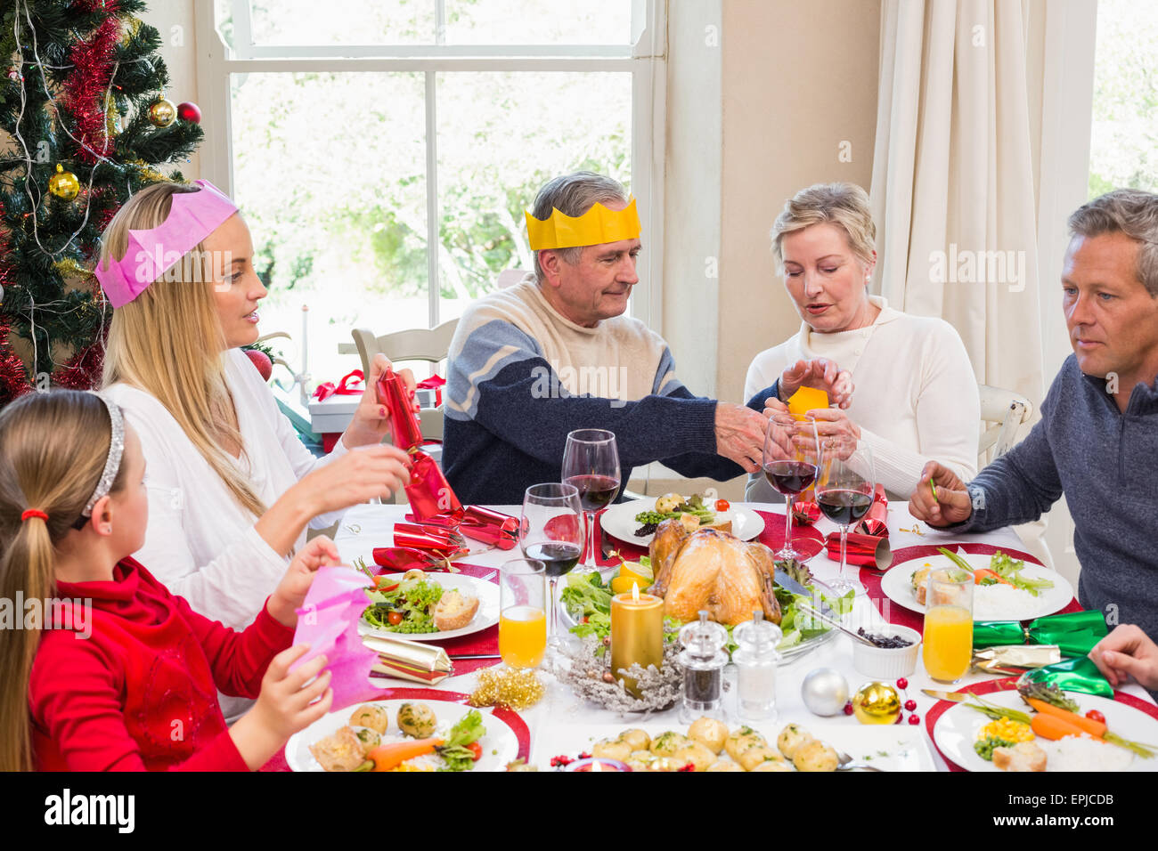 Family in party hat having fun at christmas time Stock Photo - Alamy