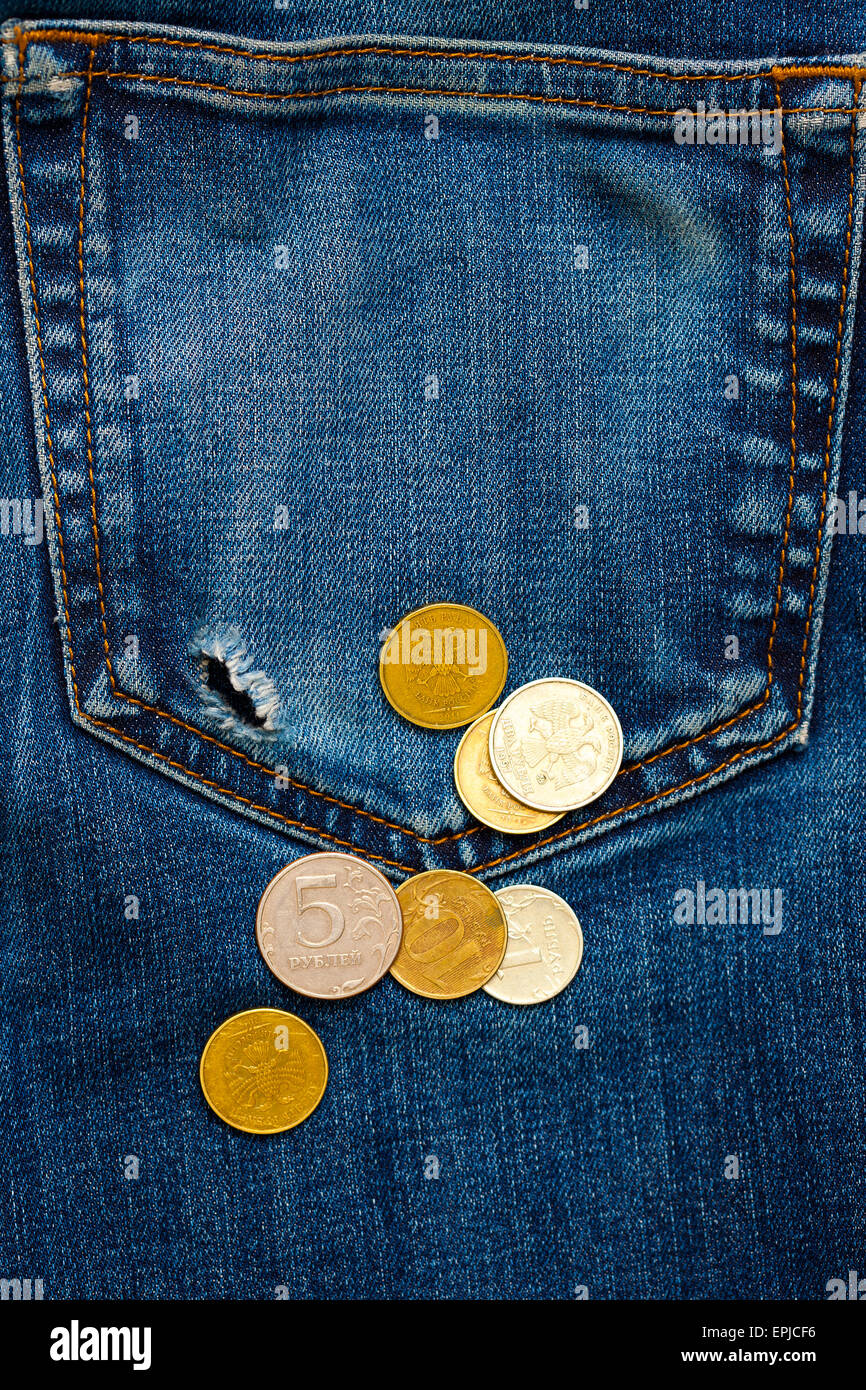 pocket with hole and coins Stock Photo - Alamy