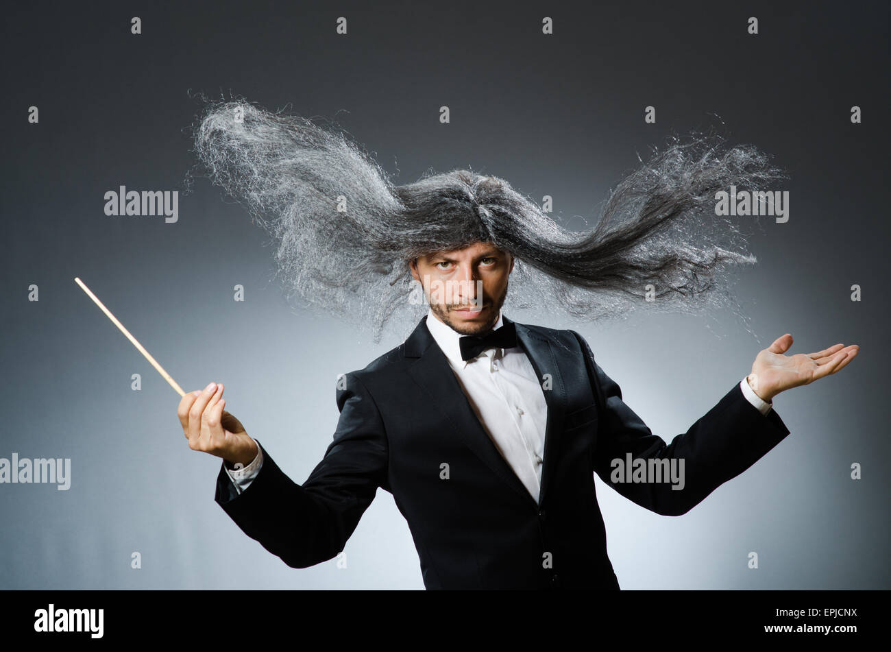 Funny conductor with long grey hair Stock Photo - Alamy