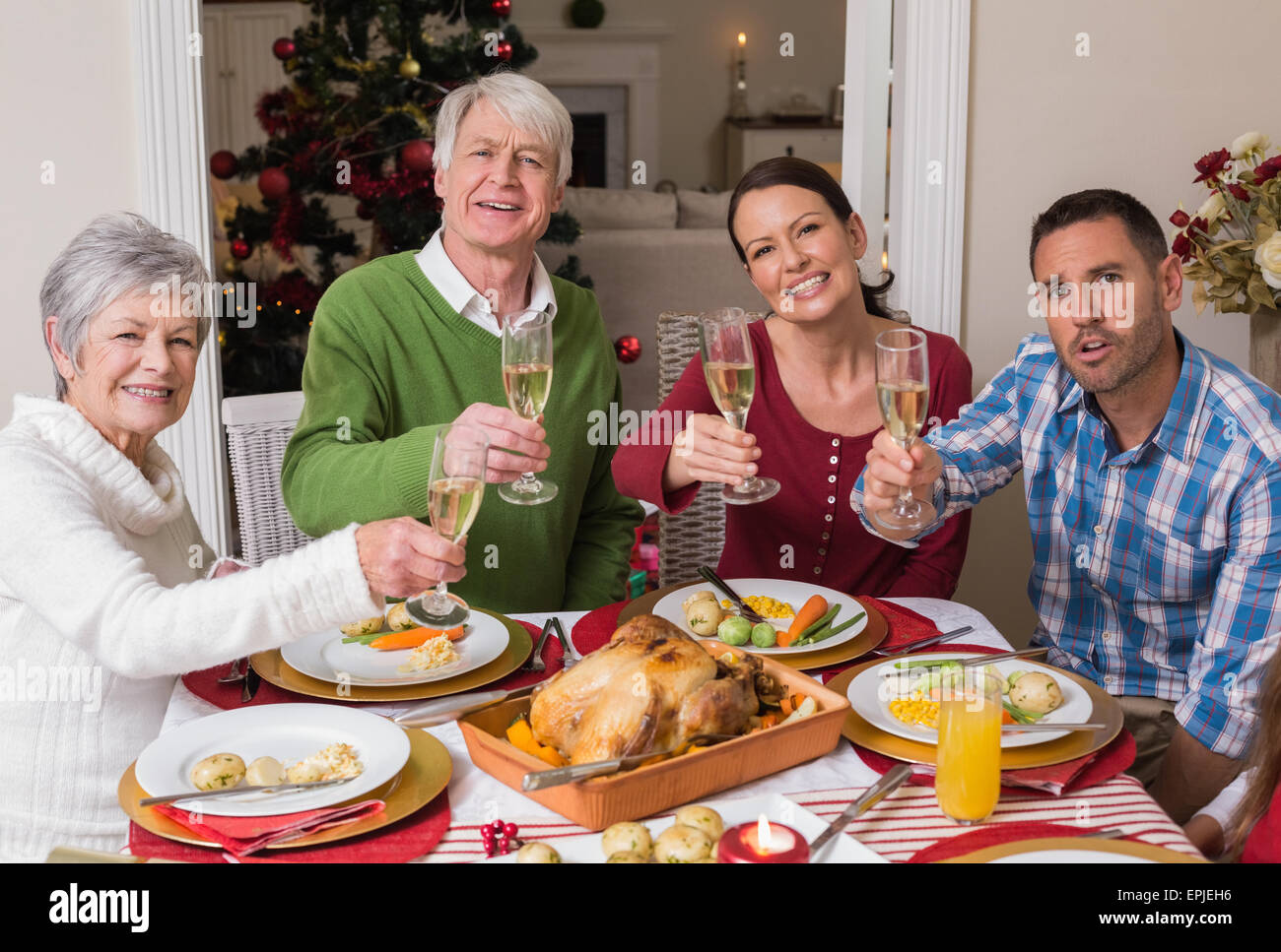 Happy family toasting at camera during christmas dinner Stock Photo - Alamy
