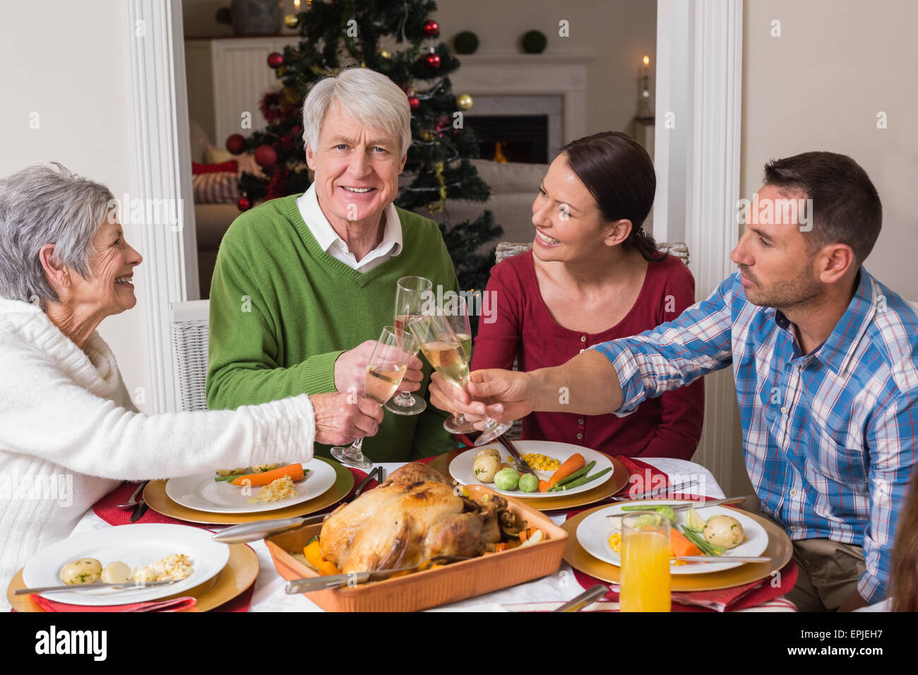 Portrait of happy family toasting at christmas dinner Stock Photo - Alamy