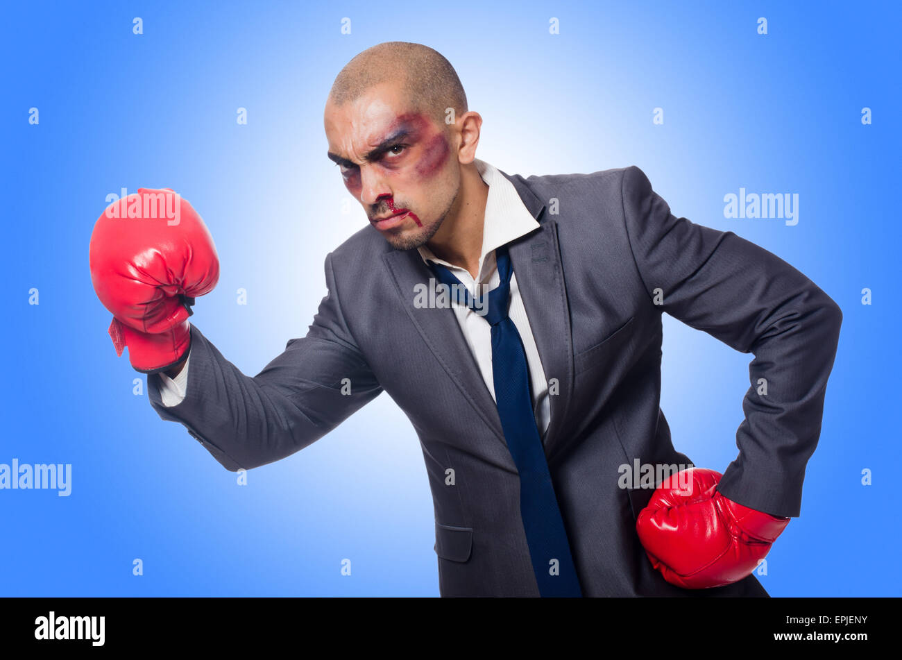 Badly beaten businessman with boxing gloves Stock Photo - Alamy