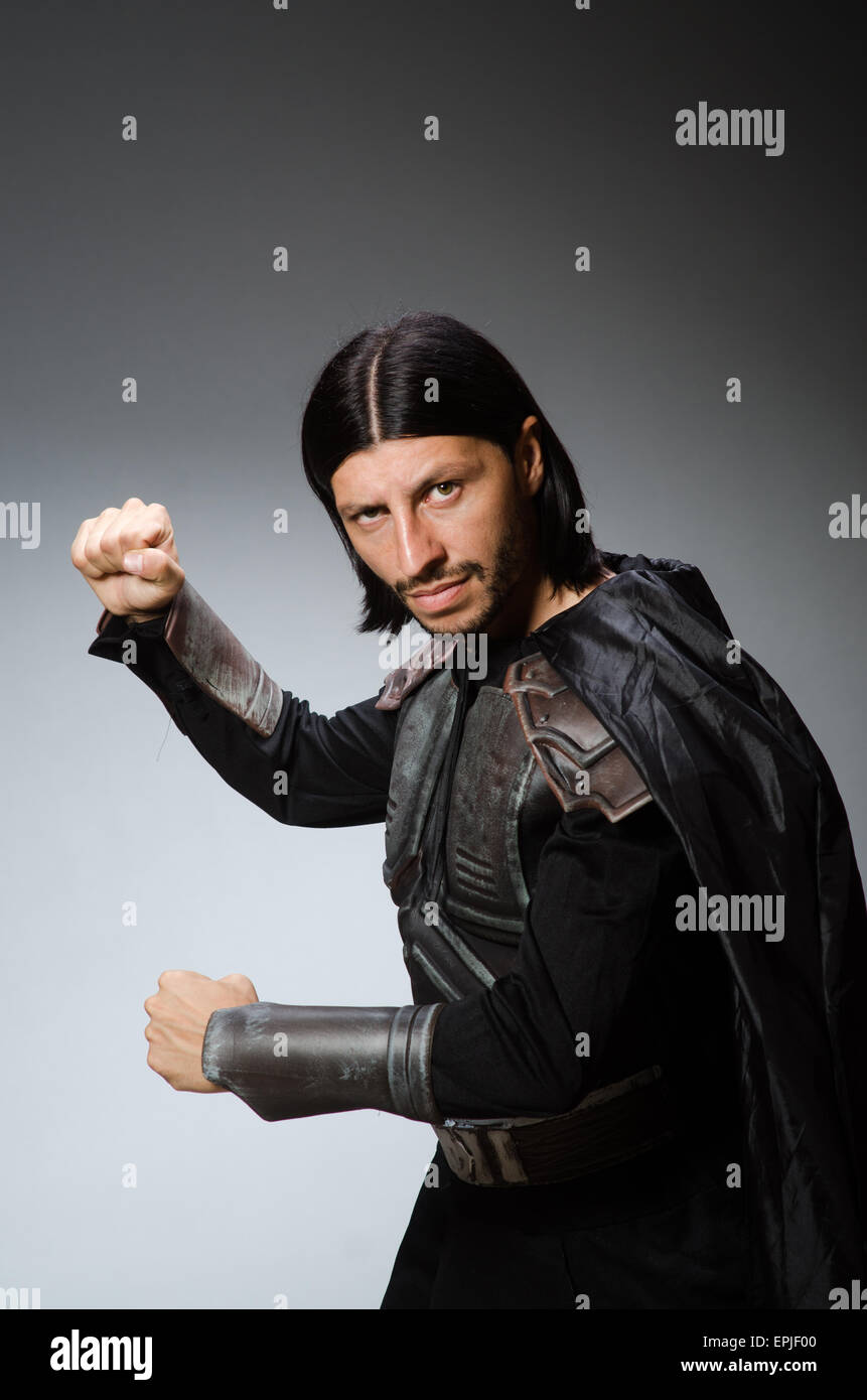 Angry warrior against dark background Stock Photo - Alamy