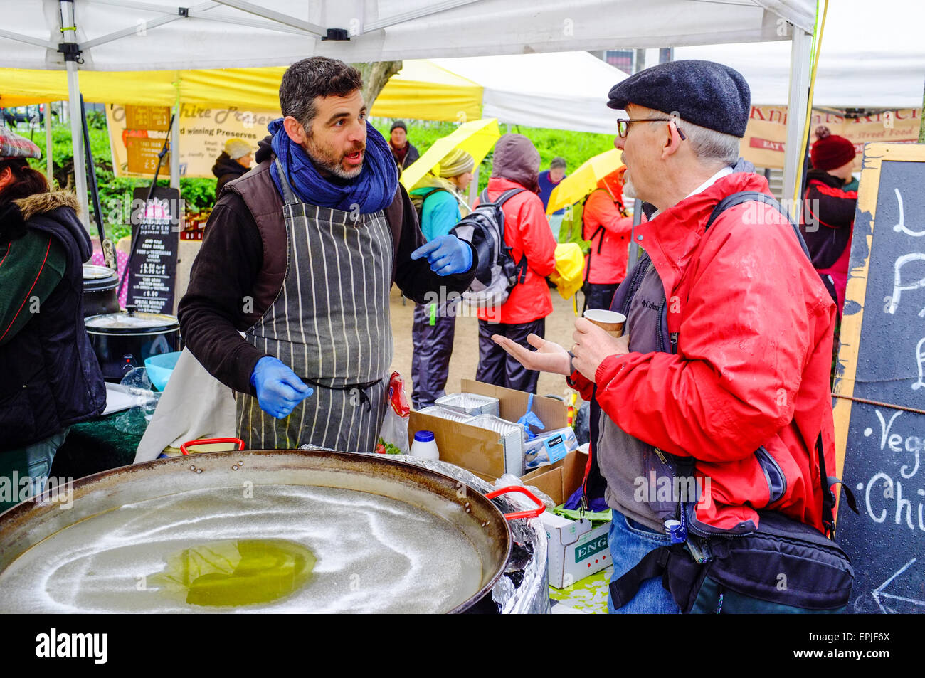 Paella cook explaining his technique to a customer at Stockbridge ...