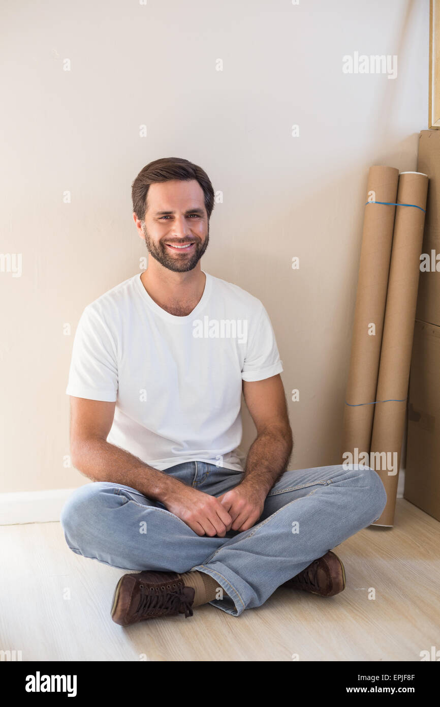 Happy man sitting on the floor Stock Photo - Alamy