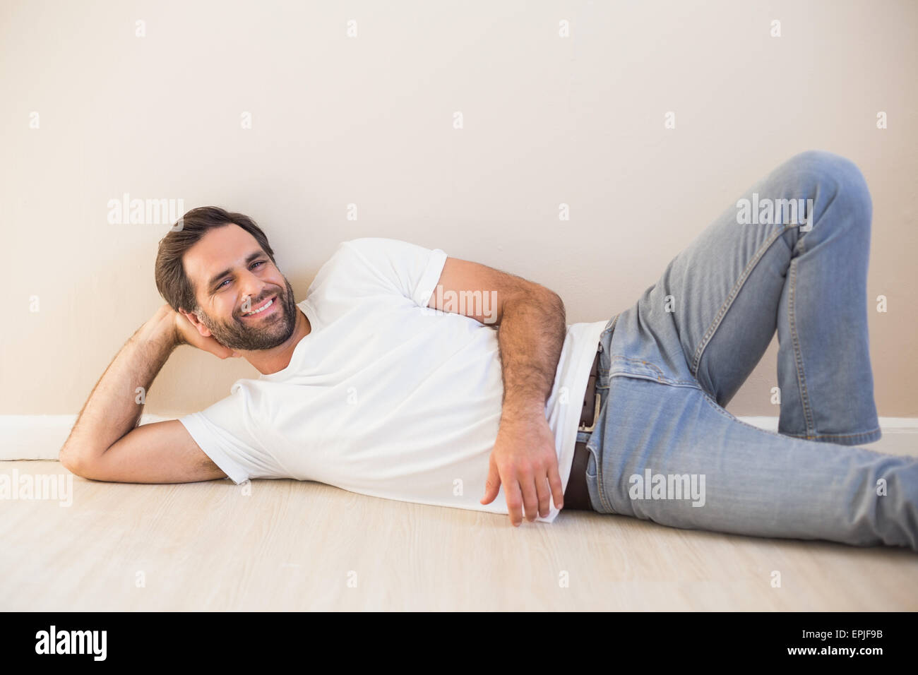 Happy man lying on the floor Stock Photo - Alamy
