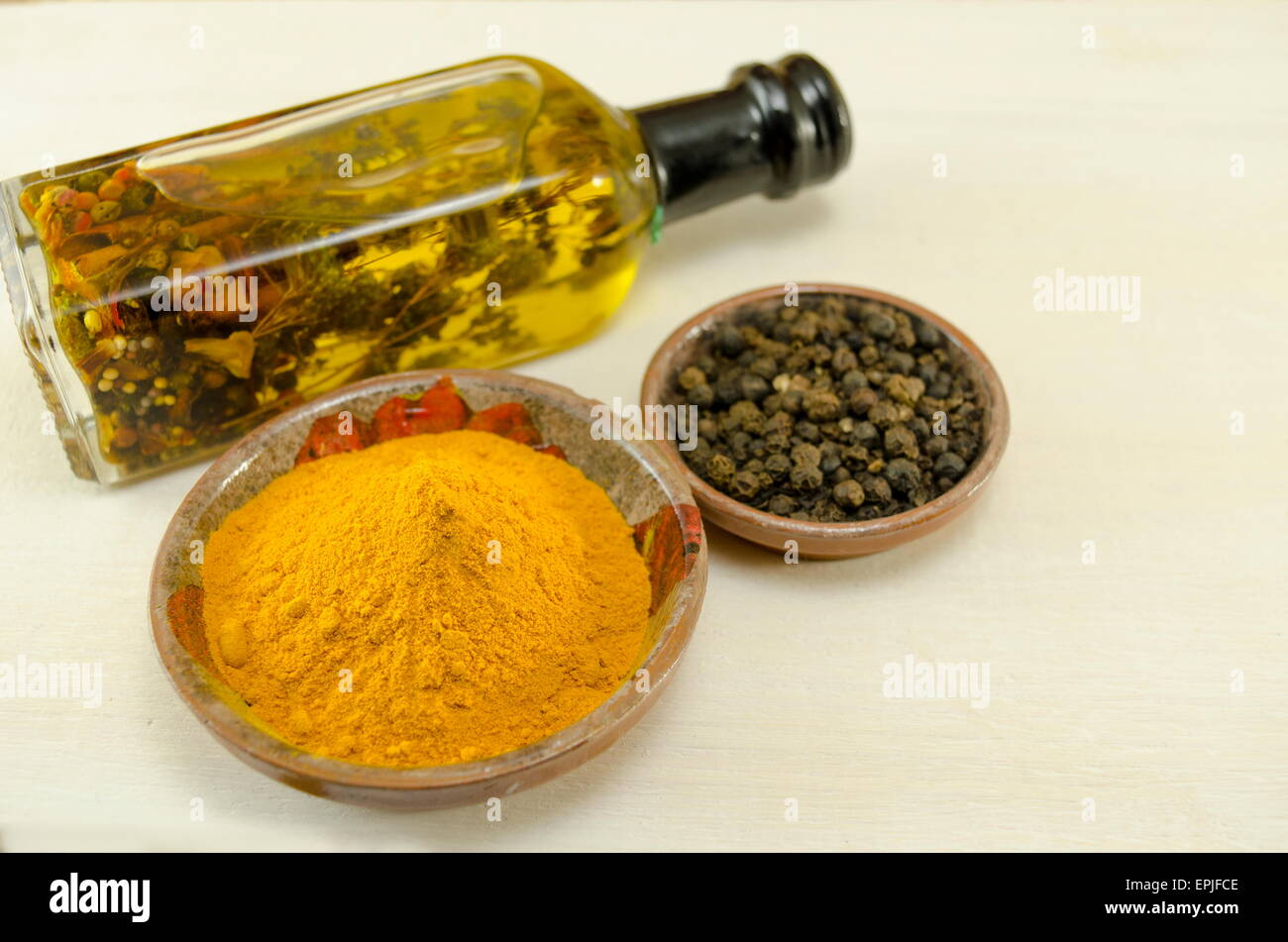 Curry pepper and olive oil on a table close up Stock Photo - Alamy