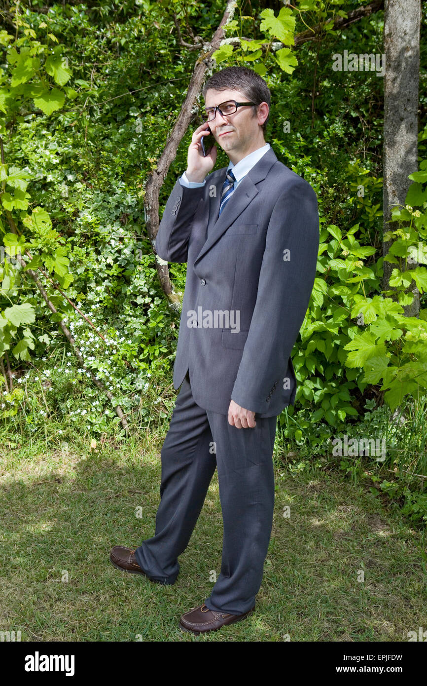 Happy businessman outdoor talking through mobile phone Stock Photo - Alamy