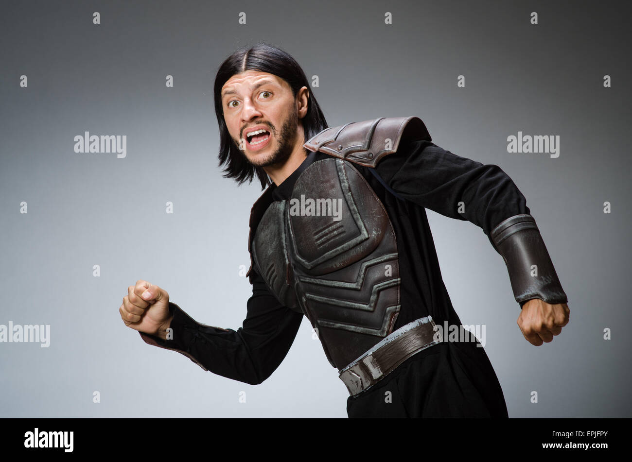 Angry warrior against dark background Stock Photo - Alamy