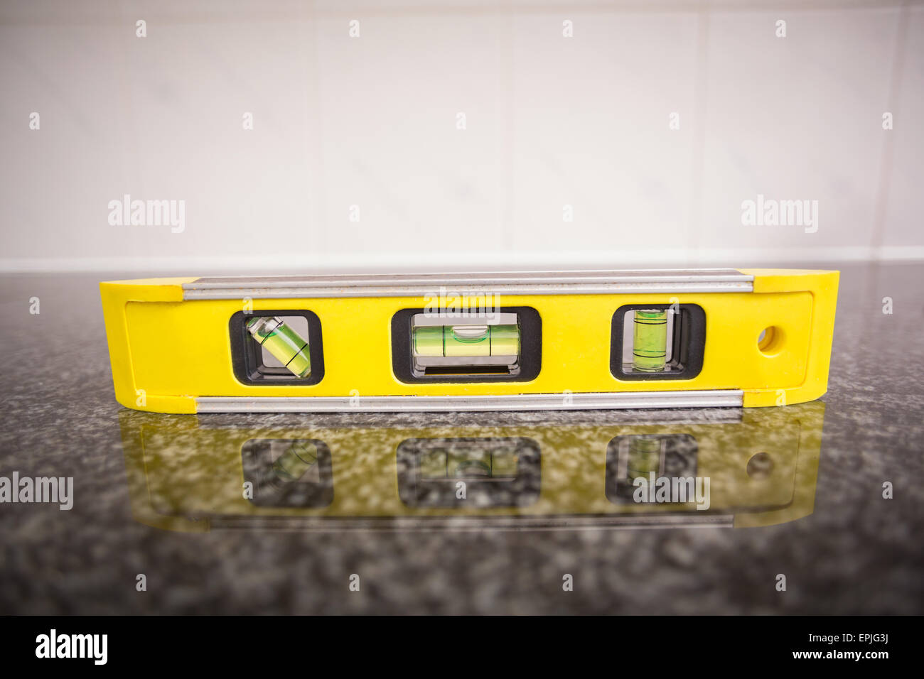 Spirit level on the counter Stock Photo - Alamy
