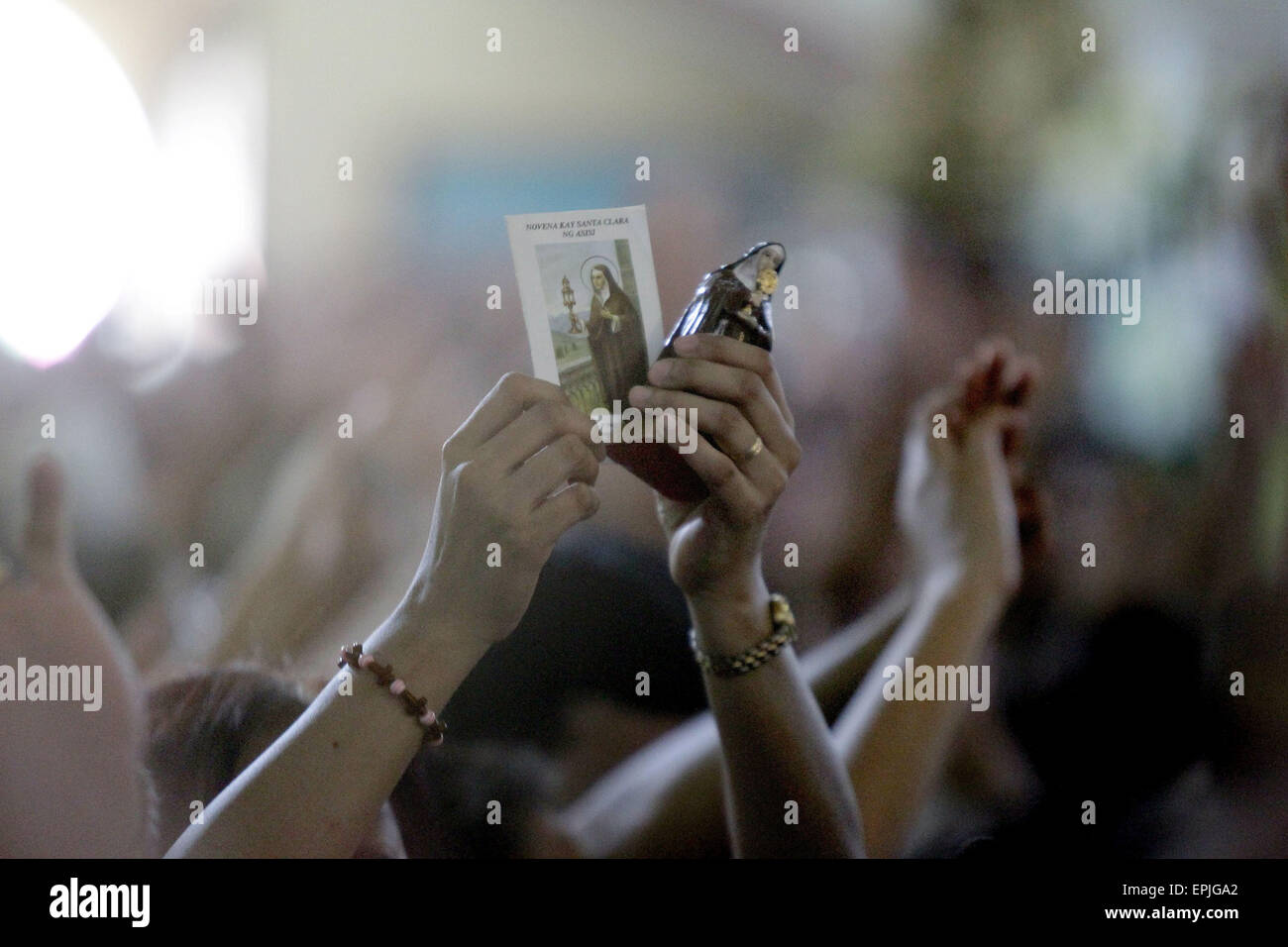 Bulacan Province, Philippines. 19th May, 2015. A devotee holds a ...