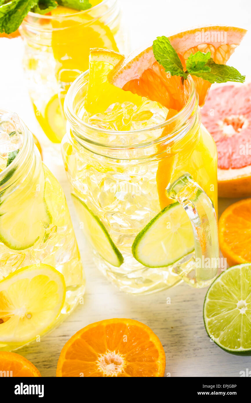 Infused water with fresh citrus fruits and ice Stock Photo - Alamy