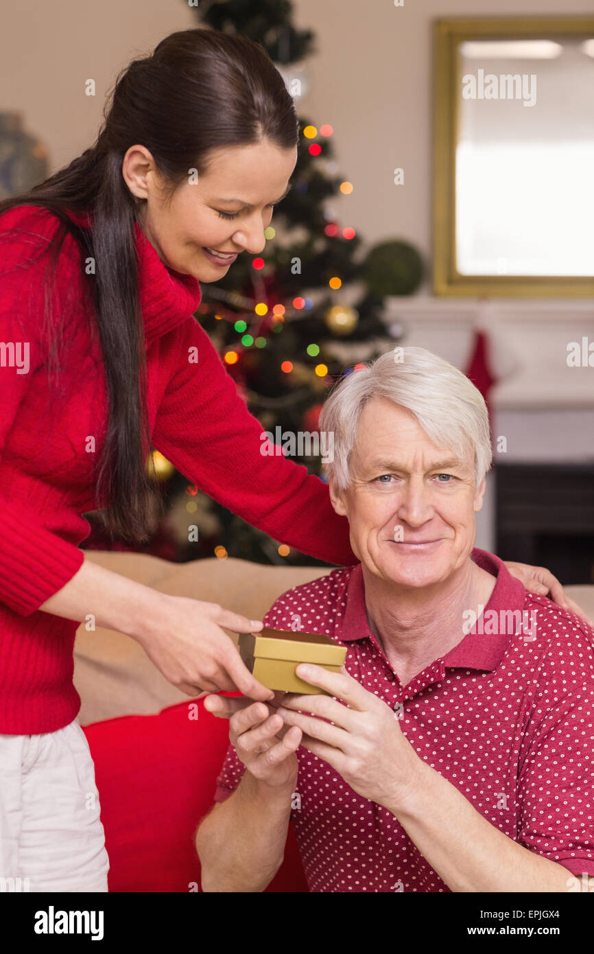 Happy mother offering gift to grandfather Stock Photo - Alamy