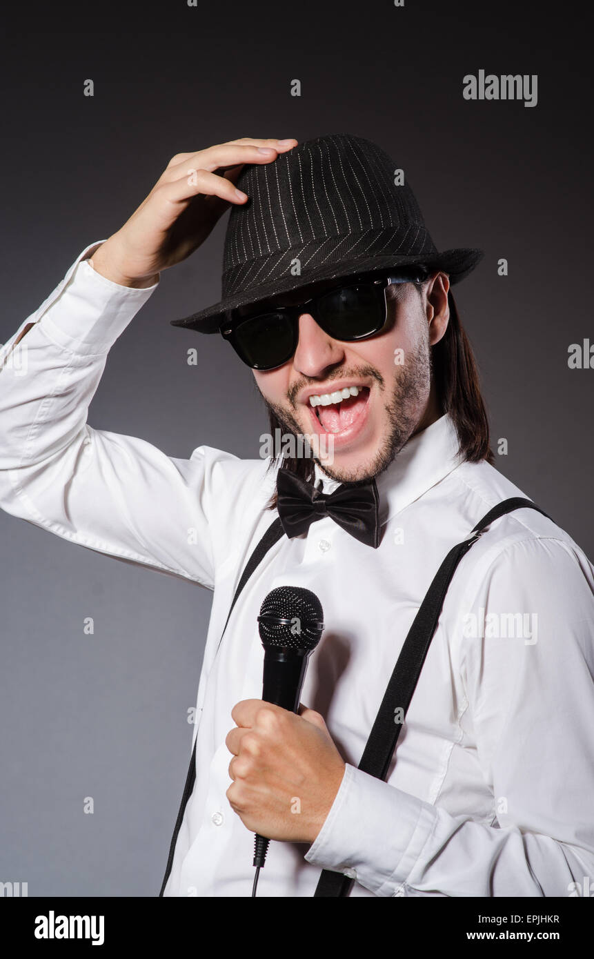 Funny singer with microphone at the concert Stock Photo - Alamy
