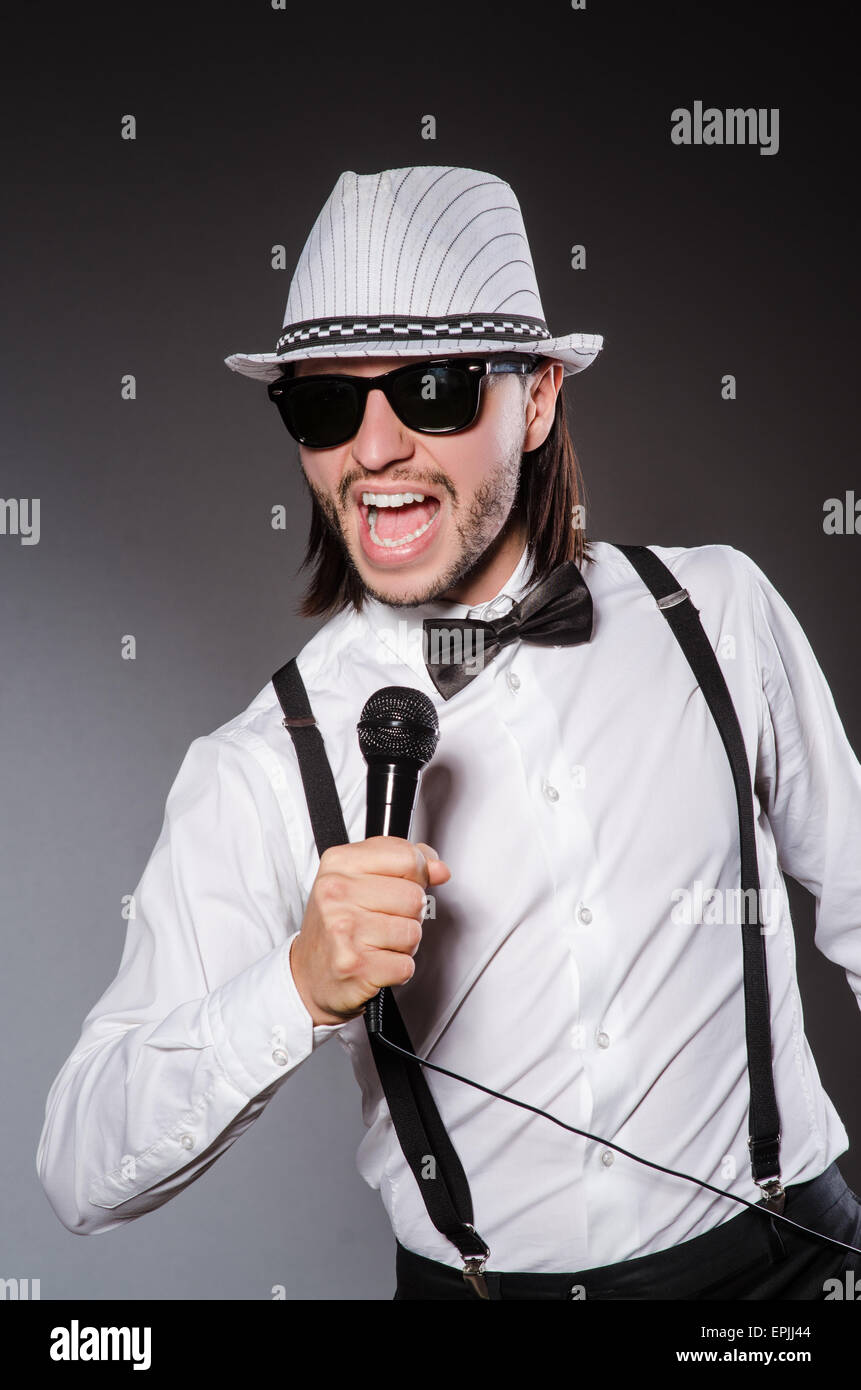 Funny singer with microphone at the concert Stock Photo - Alamy