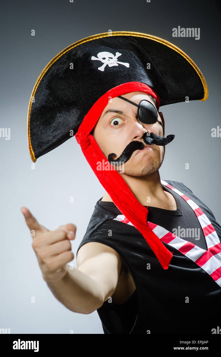 Funny pirate in the dark studio Stock Photo - Alamy