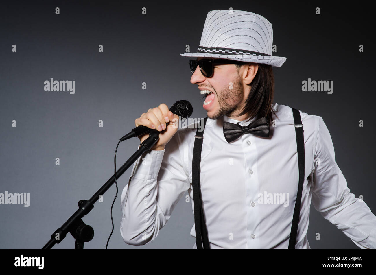 Funny singer with microphone at the concert Stock Photo - Alamy