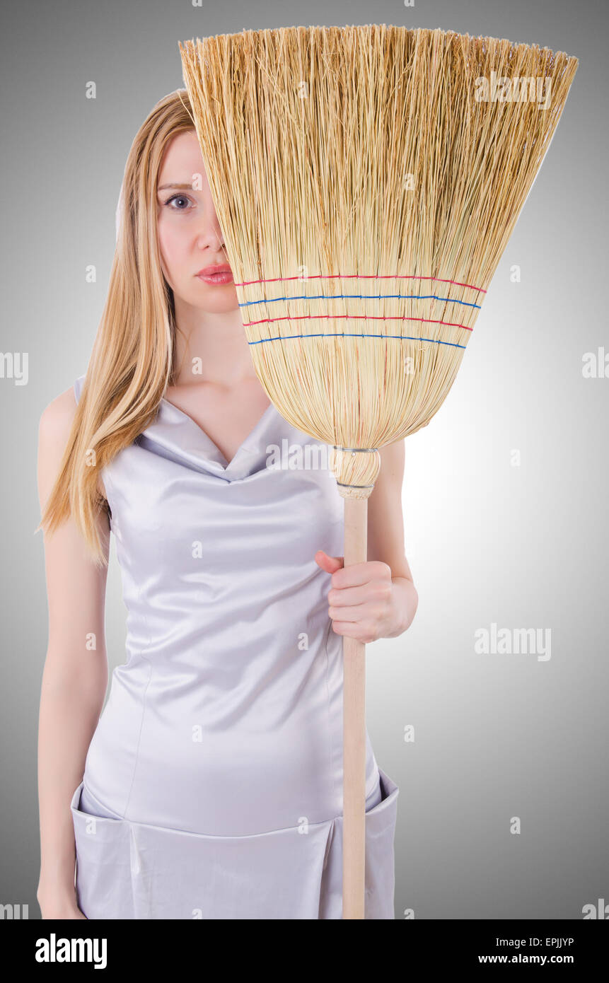 Young woman with broom on white Stock Photo - Alamy