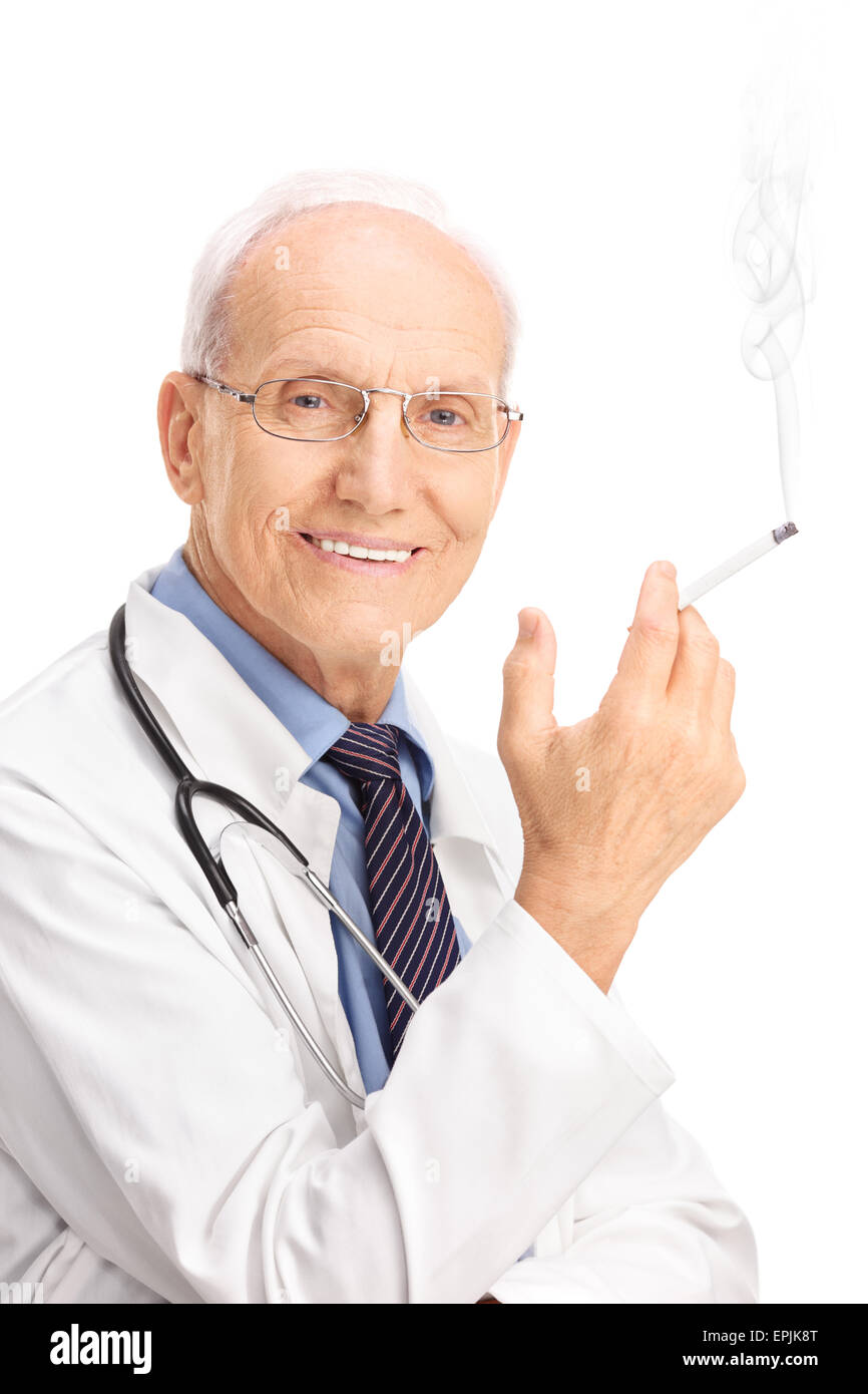 Vertical shot of a mature doctor smoking a cigarette and looking at the ...