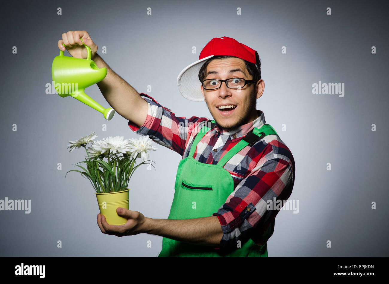 Funny man with watering can Stock Photo - Alamy