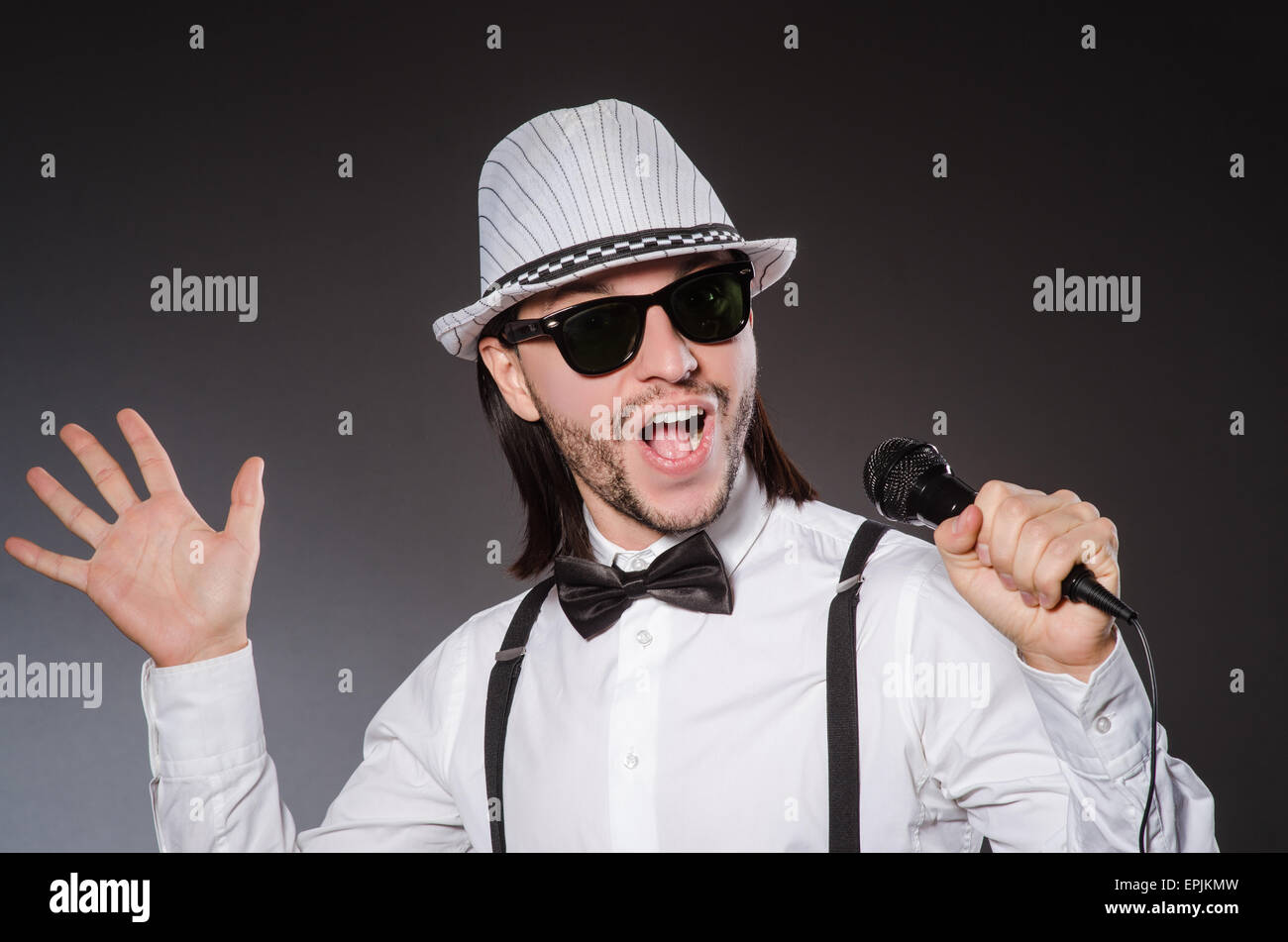 Funny singer with microphone at the concert Stock Photo - Alamy