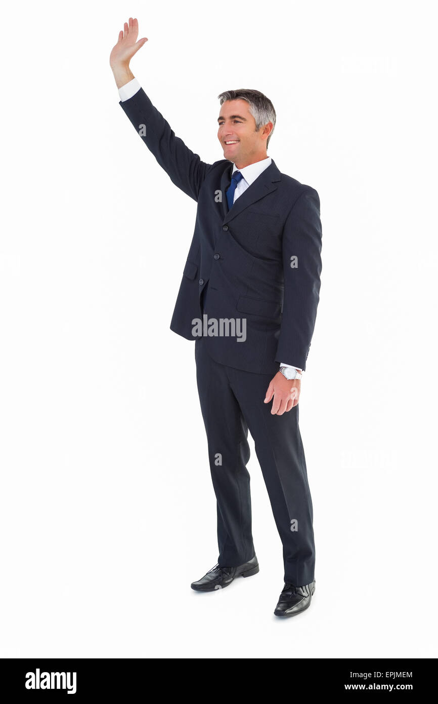 Smiling businessman in suit waving Stock Photo - Alamy