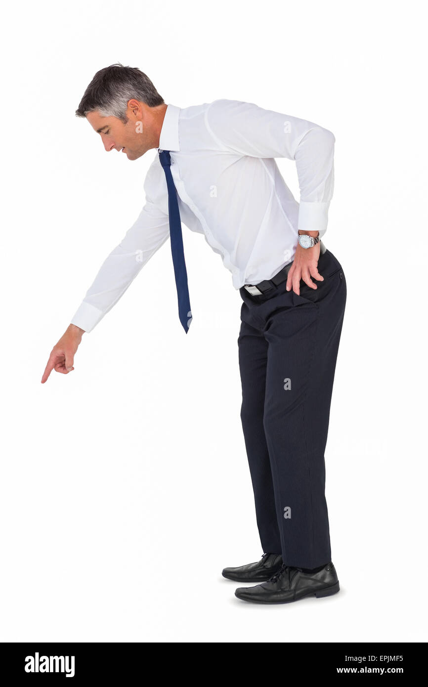 Businessman bending and pointing something down Stock Photo - Alamy