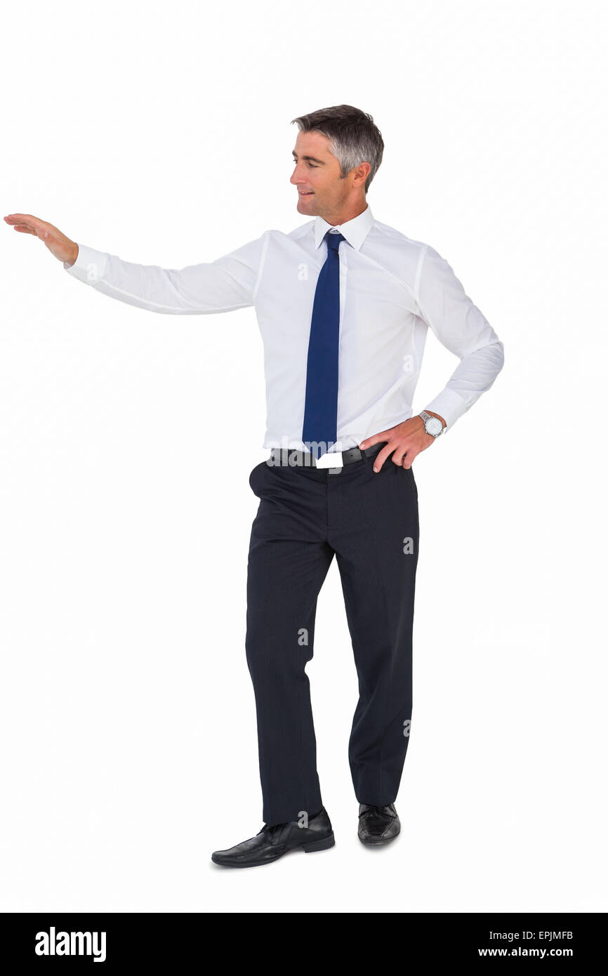 Smiling businessman with one arm out Stock Photo - Alamy