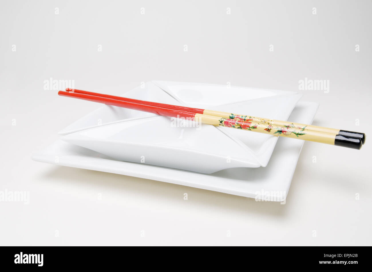 chopsticks on the plate parallel left Stock Photo - Alamy