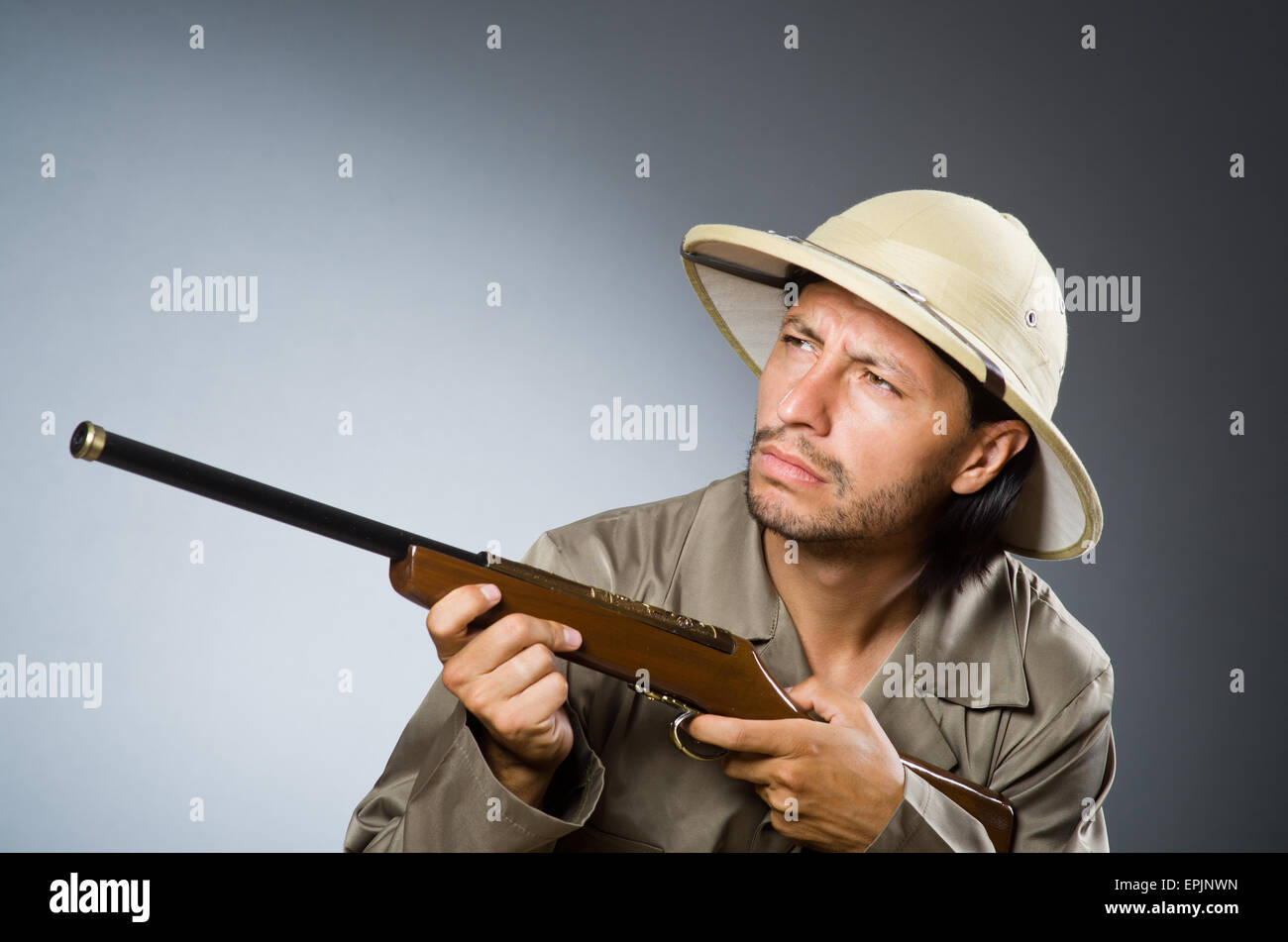 Funny safari hunter with rifle Stock Photo - Alamy