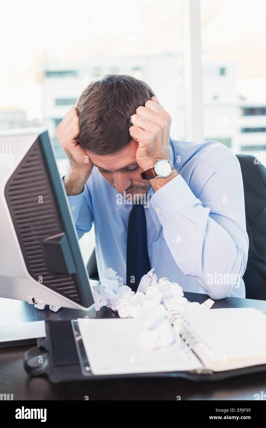 Desperate businessman at his desk Stock Photo - Alamy