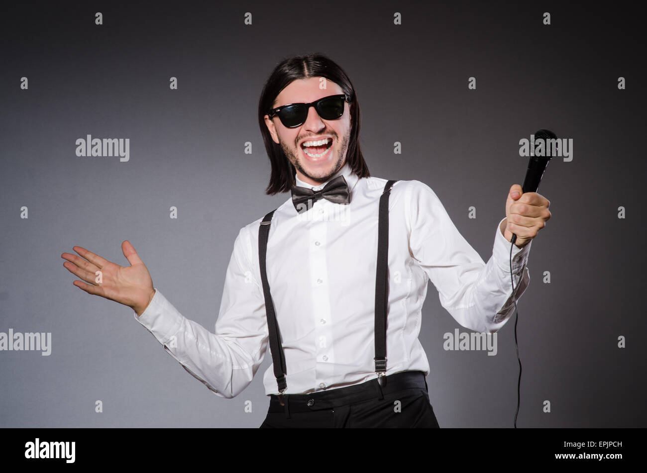 Funny singer with microphone at the concert Stock Photo - Alamy