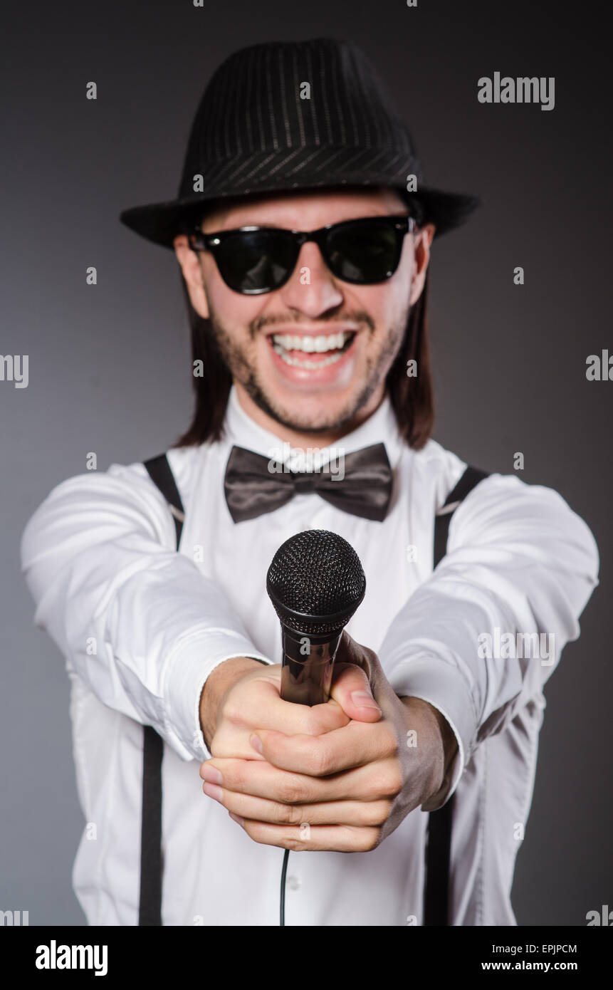 Funny singer with microphone at the concert Stock Photo - Alamy