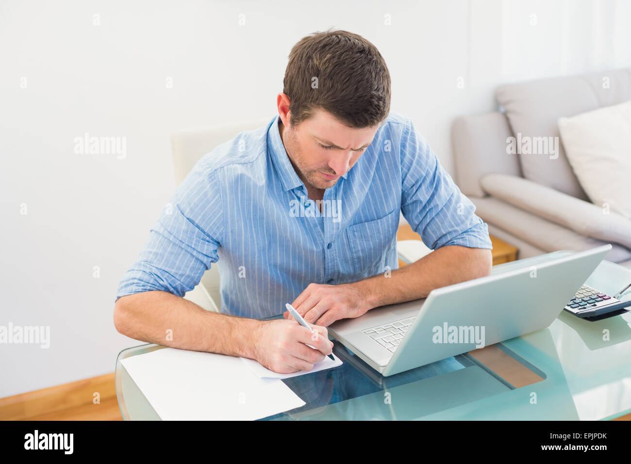 Businessman writing at his desk Stock Photo - Alamy