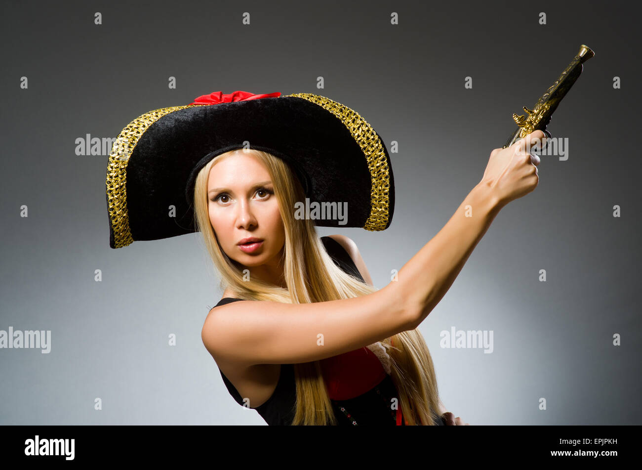 Pirate with gun against grey background Stock Photo - Alamy