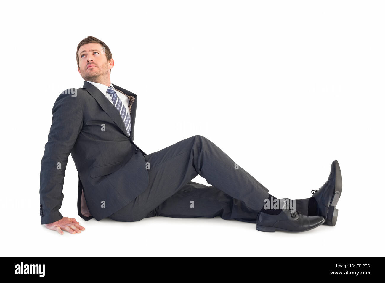 Businessman sitting and looking up Stock Photo - Alamy