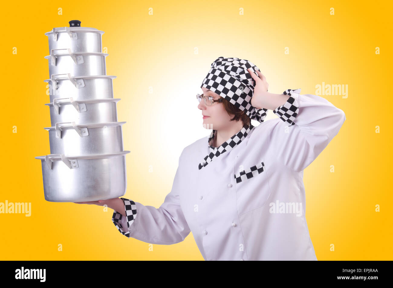 Cook with stack of pots on white Stock Photo - Alamy
