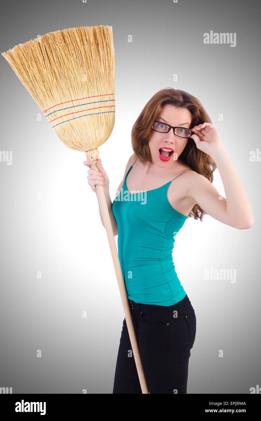 Young woman with broom on white Stock Photo - Alamy