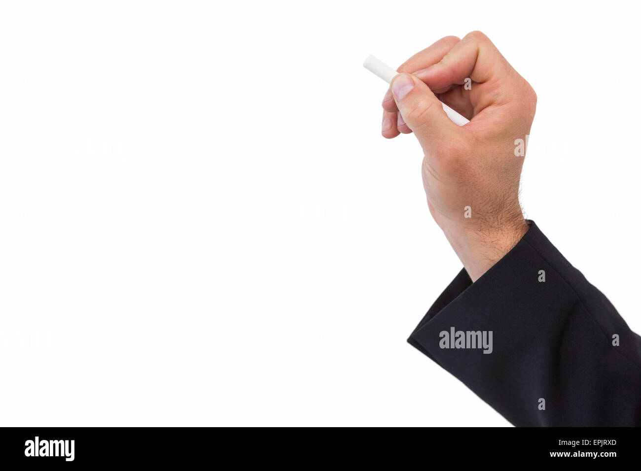 Hand holding a chalk and writing something Stock Photo - Alamy