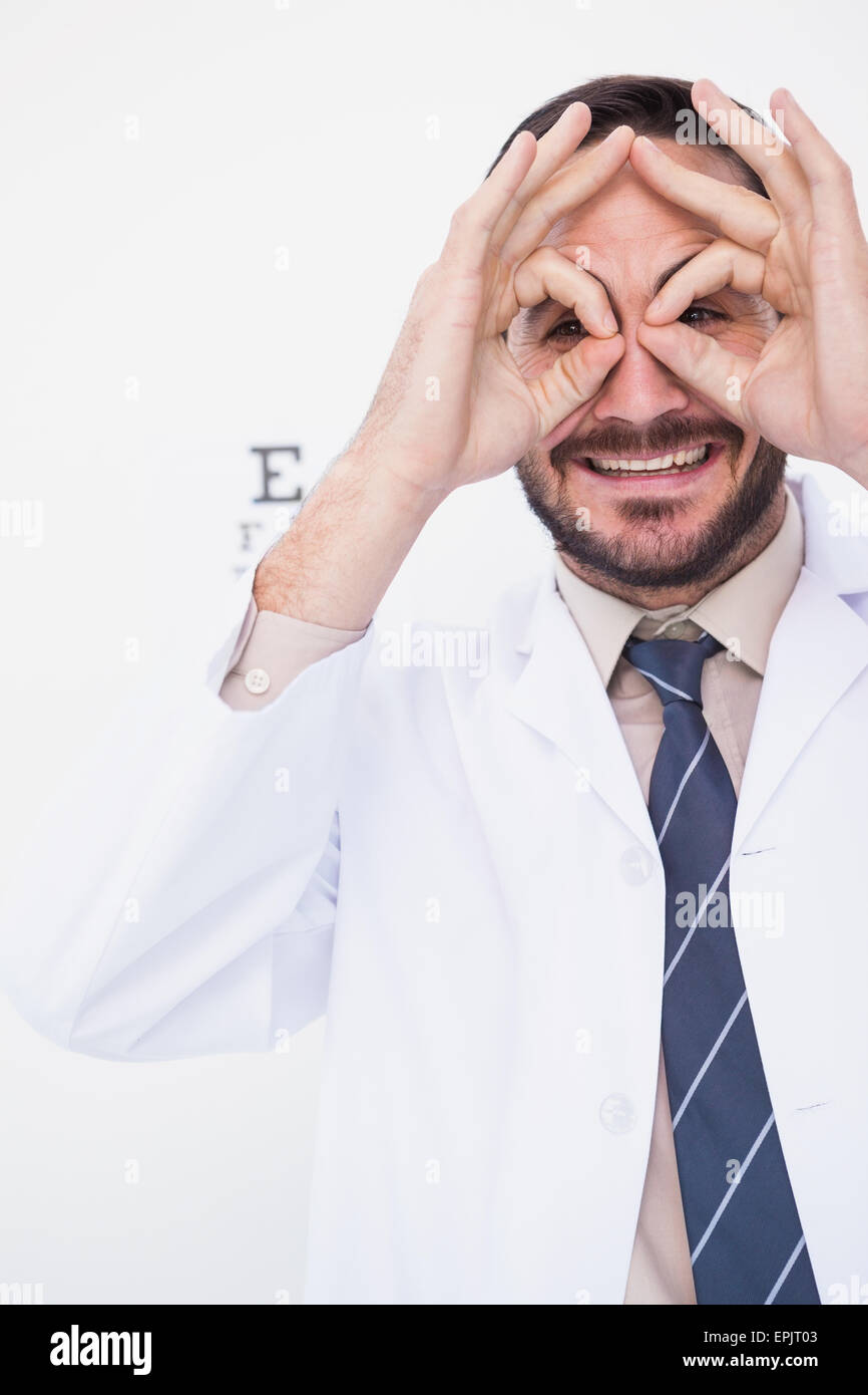 Smiling doctor forming eyeglasses with his hands Stock Photo - Alamy
